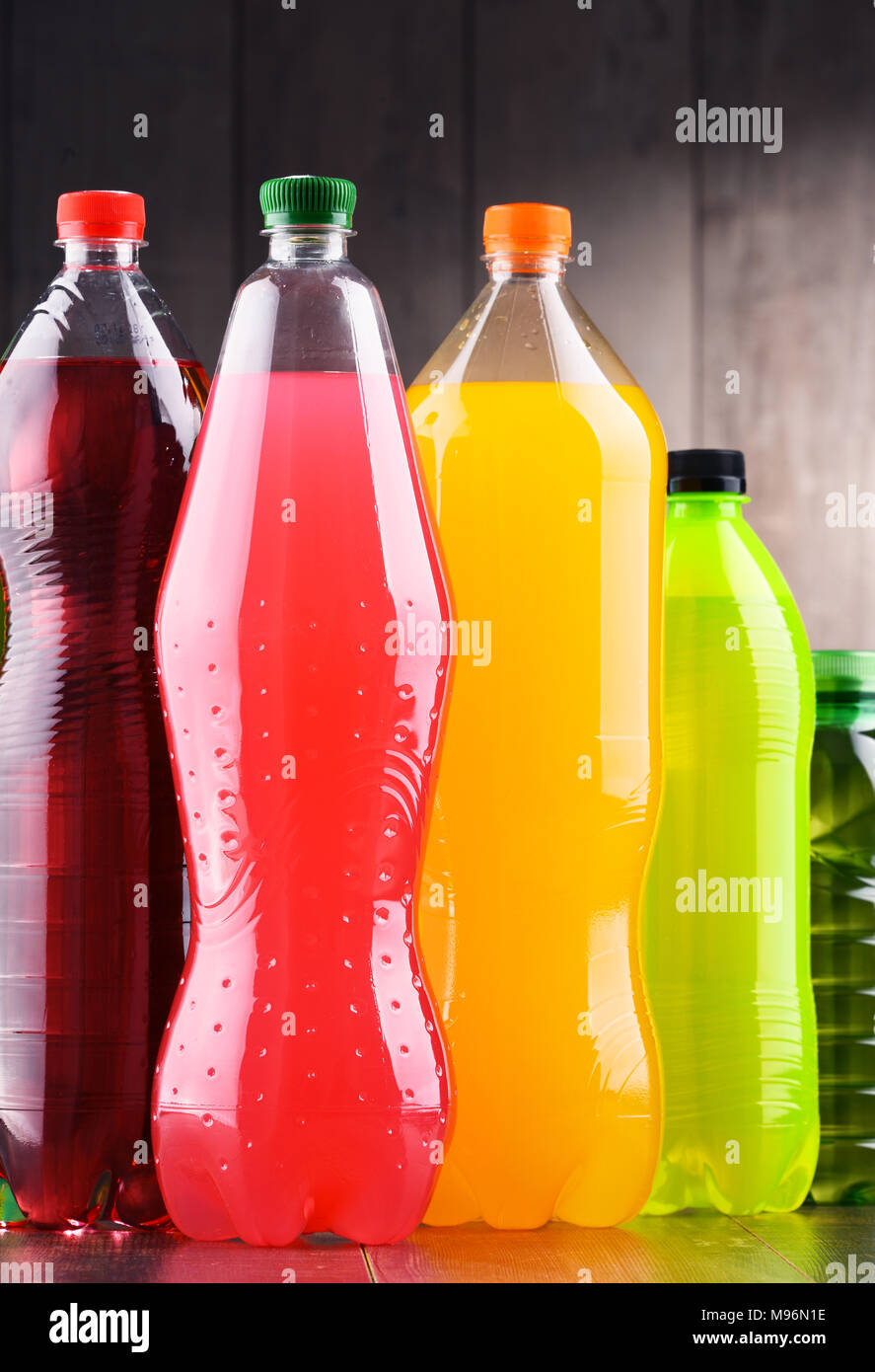 Plastic bottles of assorted carbonated soft drinks in variety of colors ...