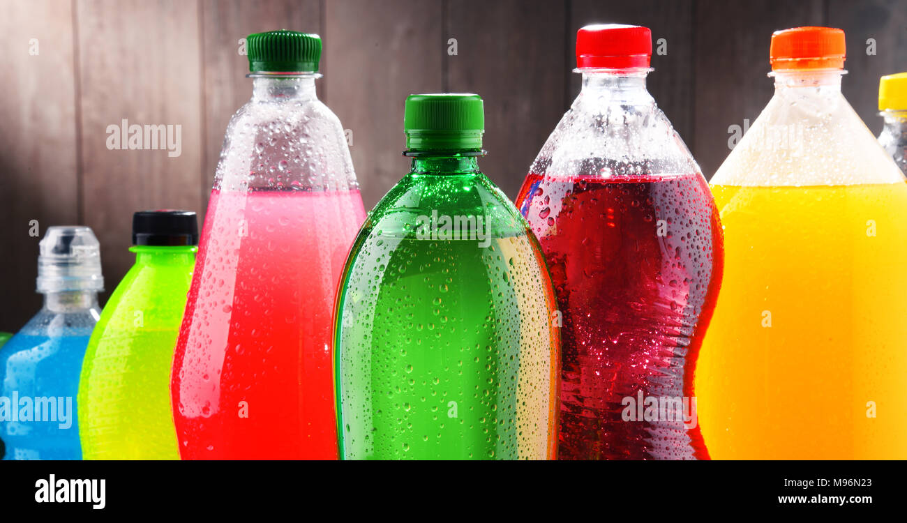 Plastic bottles of assorted carbonated soft drinks in variety of colors ...