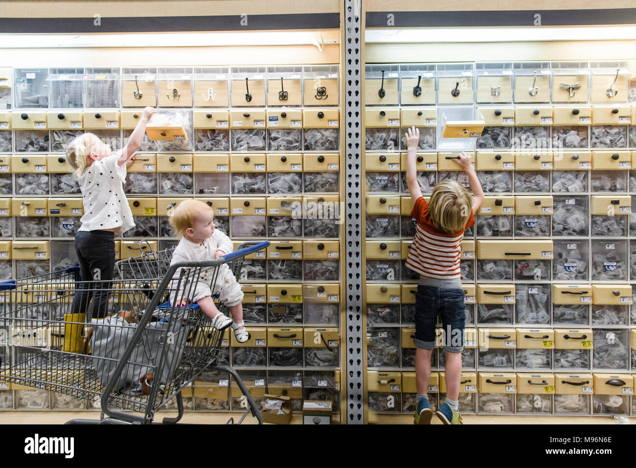 Children reaching high for boxes Stock Photo - Alamy