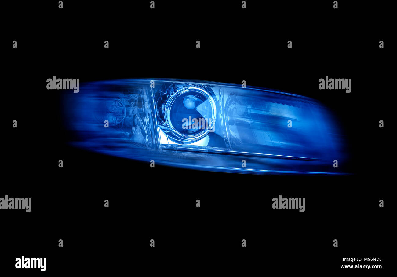 Modern automotive headlight on a black background shine blue light ...