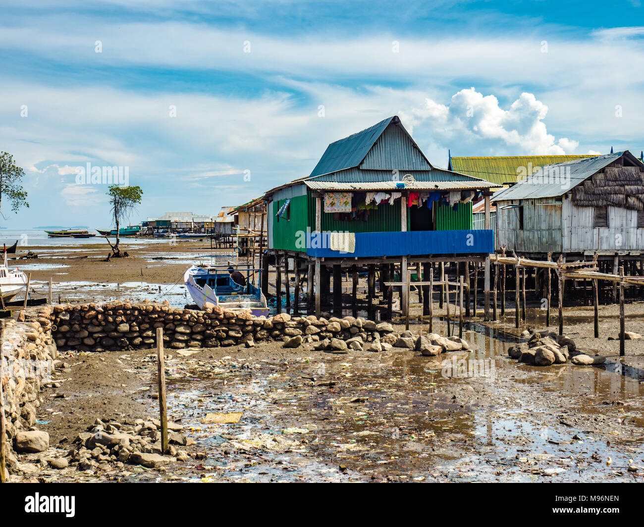 Village of Sea Gypsies during low tide. Asian traditional wooden houses ...