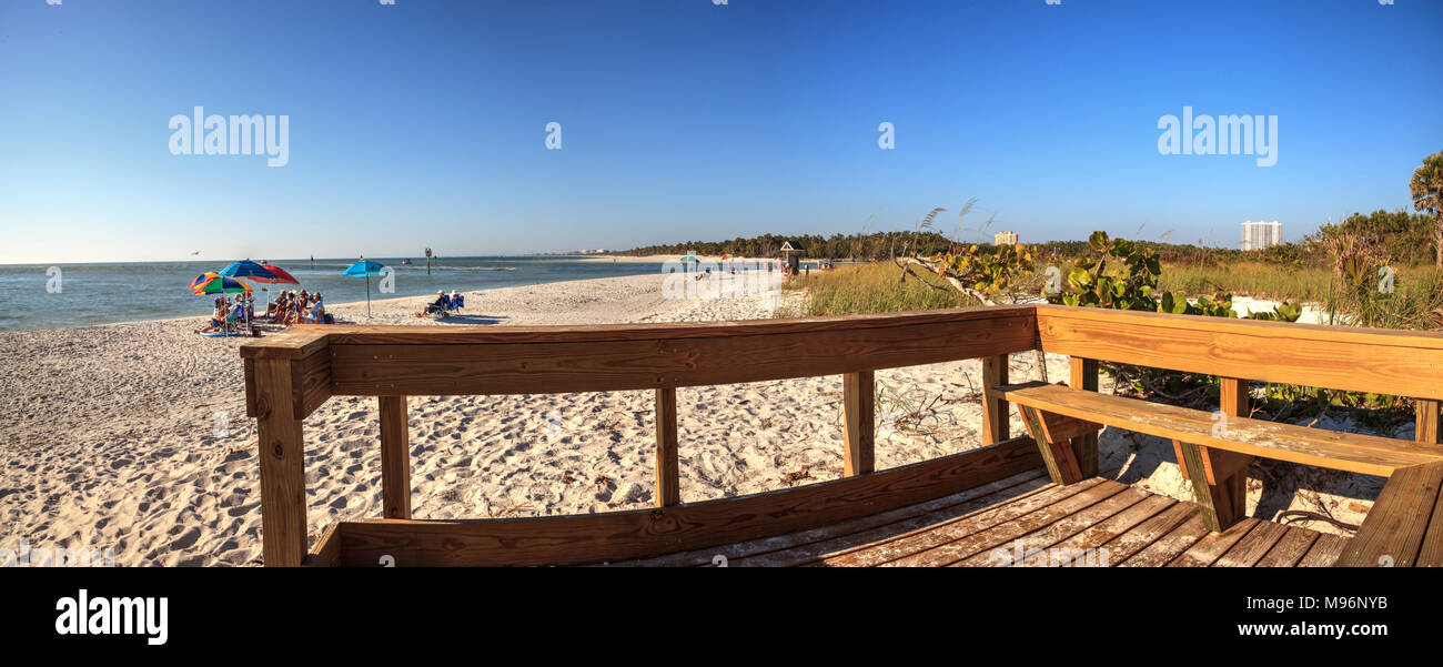Wood bench on the white sand beach of Delnor-Wiggins Pass State Park ...