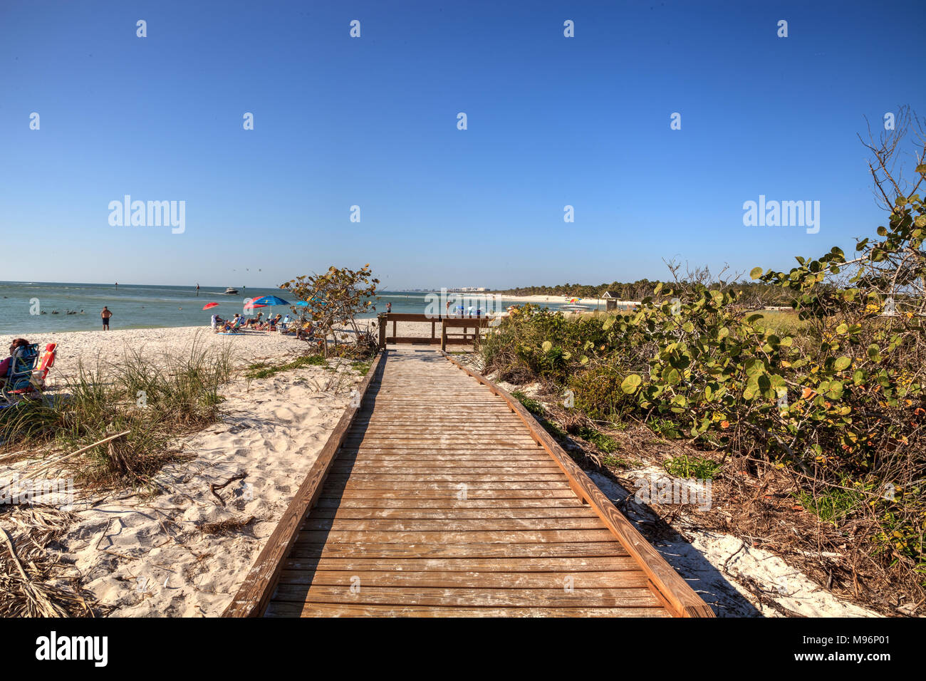 Boardwalk across the white sand beach of Delnor-Wiggins Pass State Park ...