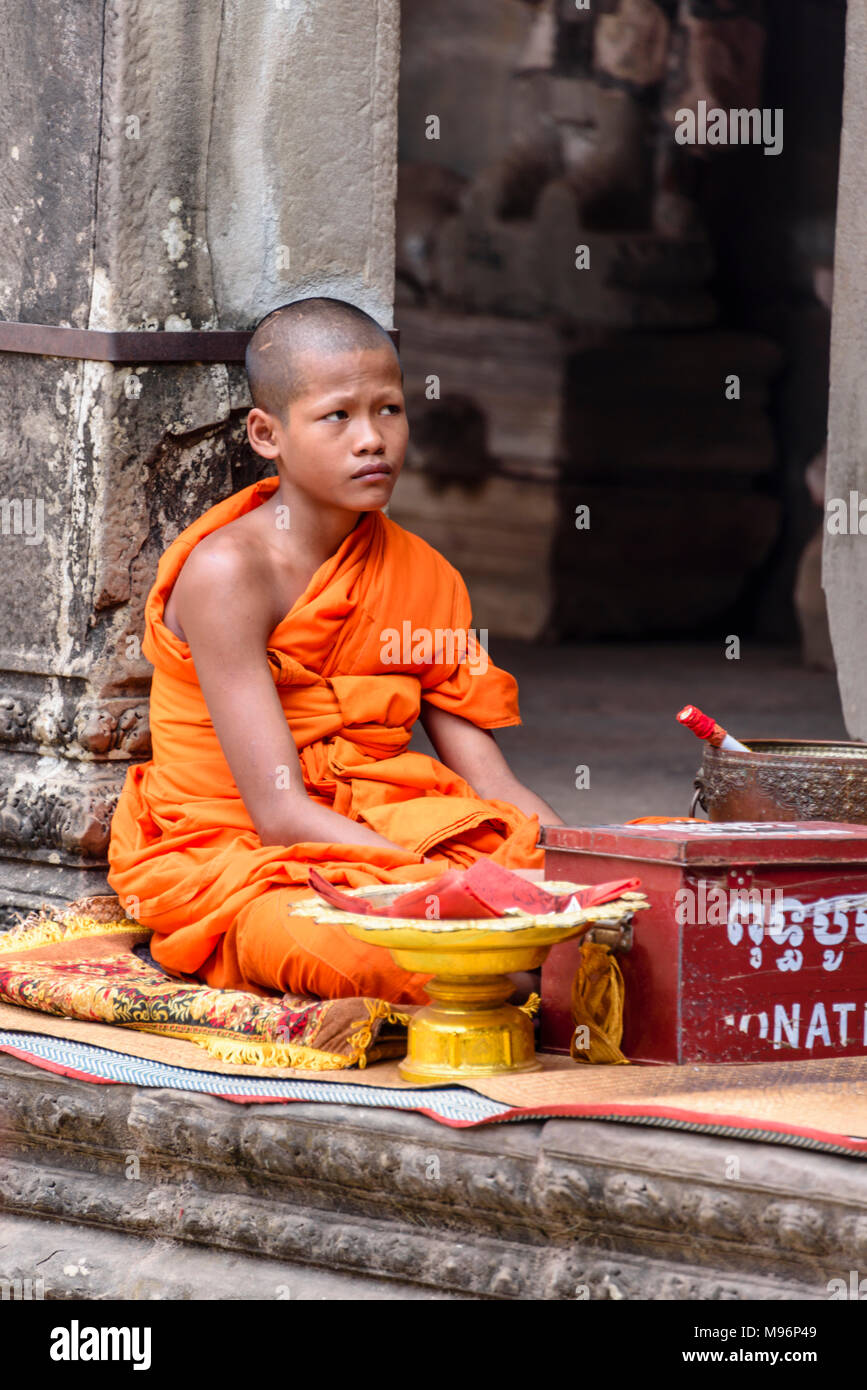 Monk wearing saffron robes at the UNESCO World Heritage Site of Angkor ...
