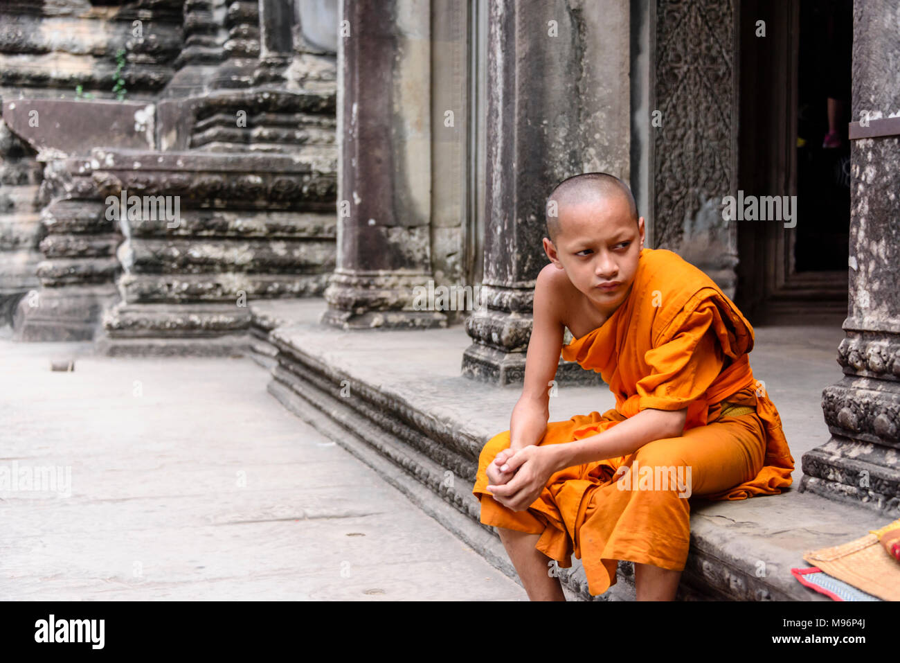 Monk wearing saffron robes at the UNESCO World Heritage Site of Angkor ...