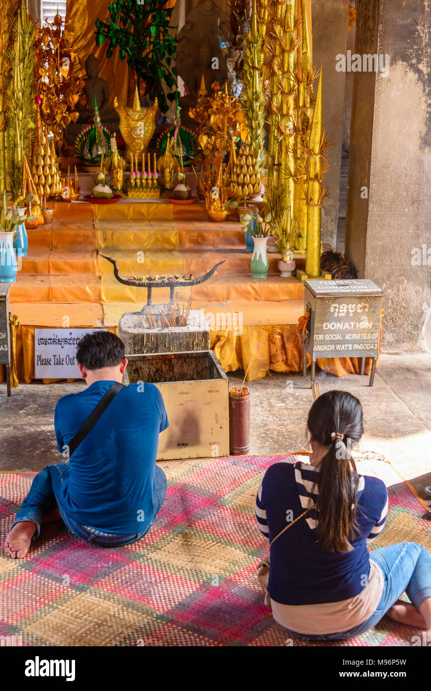 Man family praying altar visiting hi-res stock photography and images ...