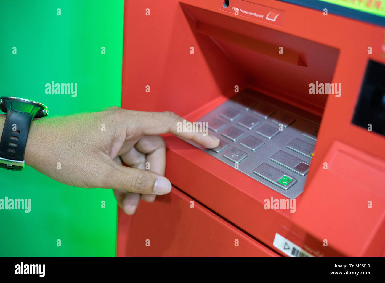 A man hand entering PIN/pass code on ATM/bank machine keypad Stock ...