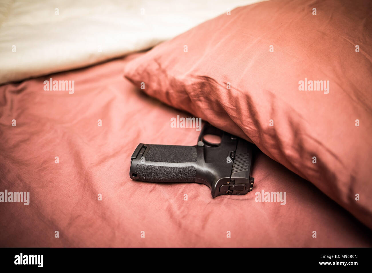 Pistol an bed hi-res stock photography and images - Alamy