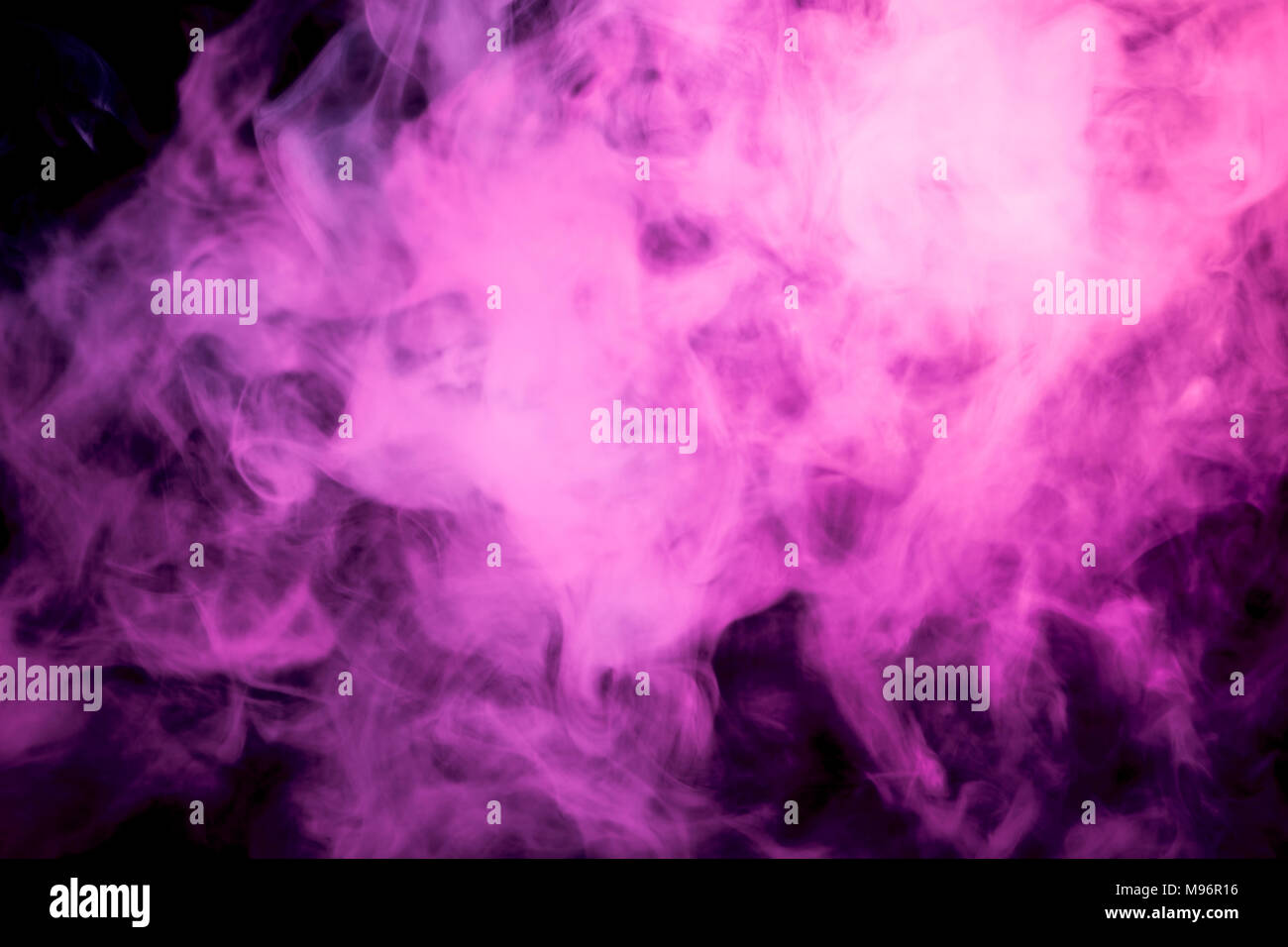 Pink cloud of smoke of black isolated background. Background from the ...