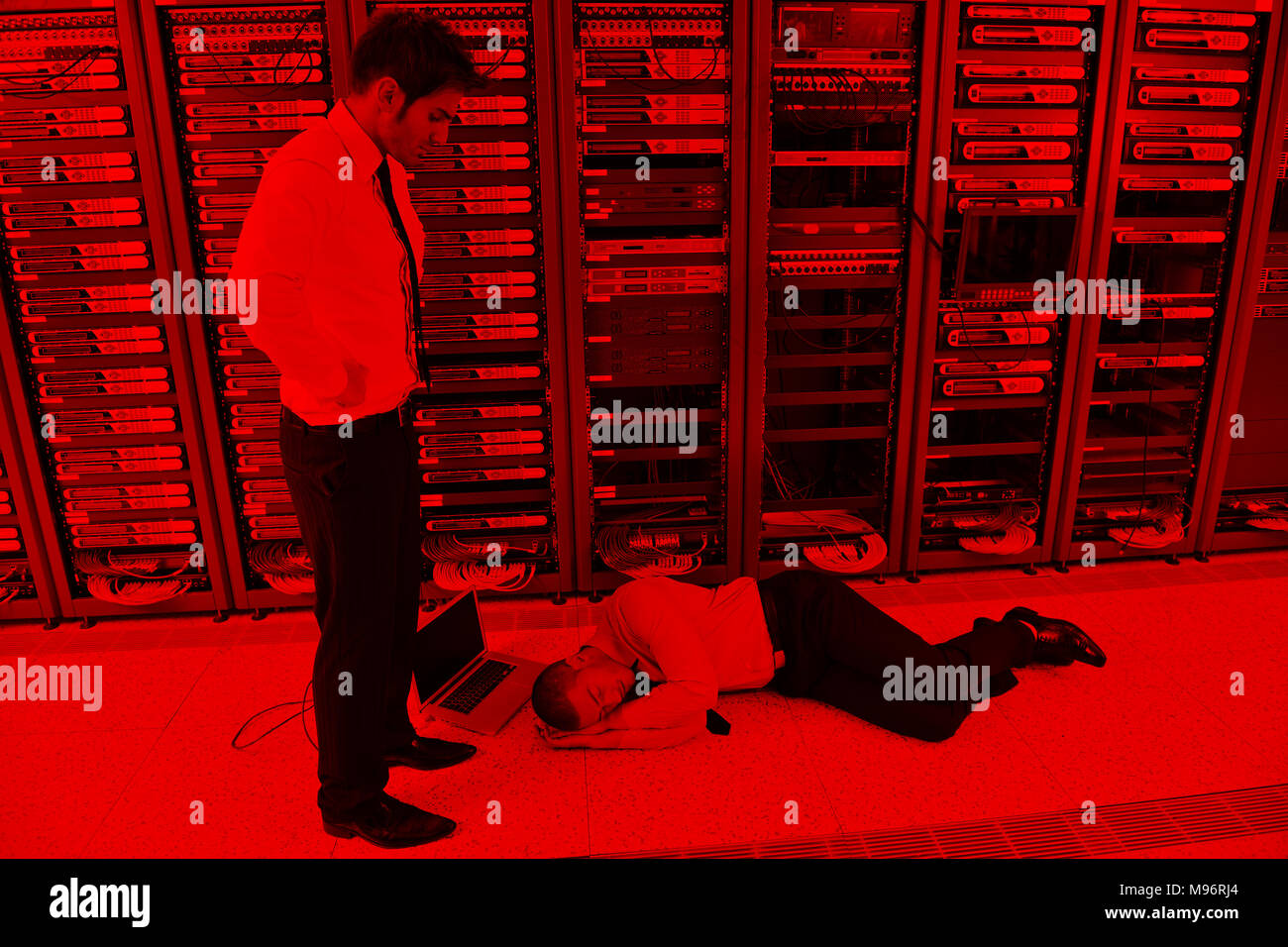 it business man in network server room have problems and looking for ...