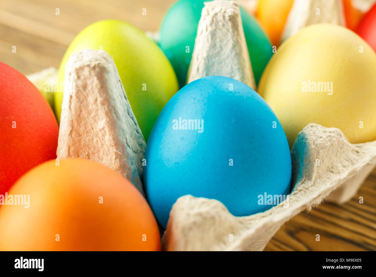 Bright Easter eggs in a special stand. Happy Easter. Close-up, blurred background. The texture ...