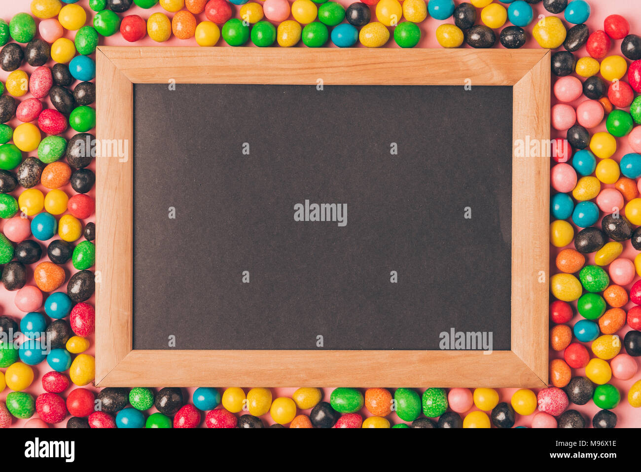 top view of empty chalkboard and colorful candies Stock Photo - Alamy
