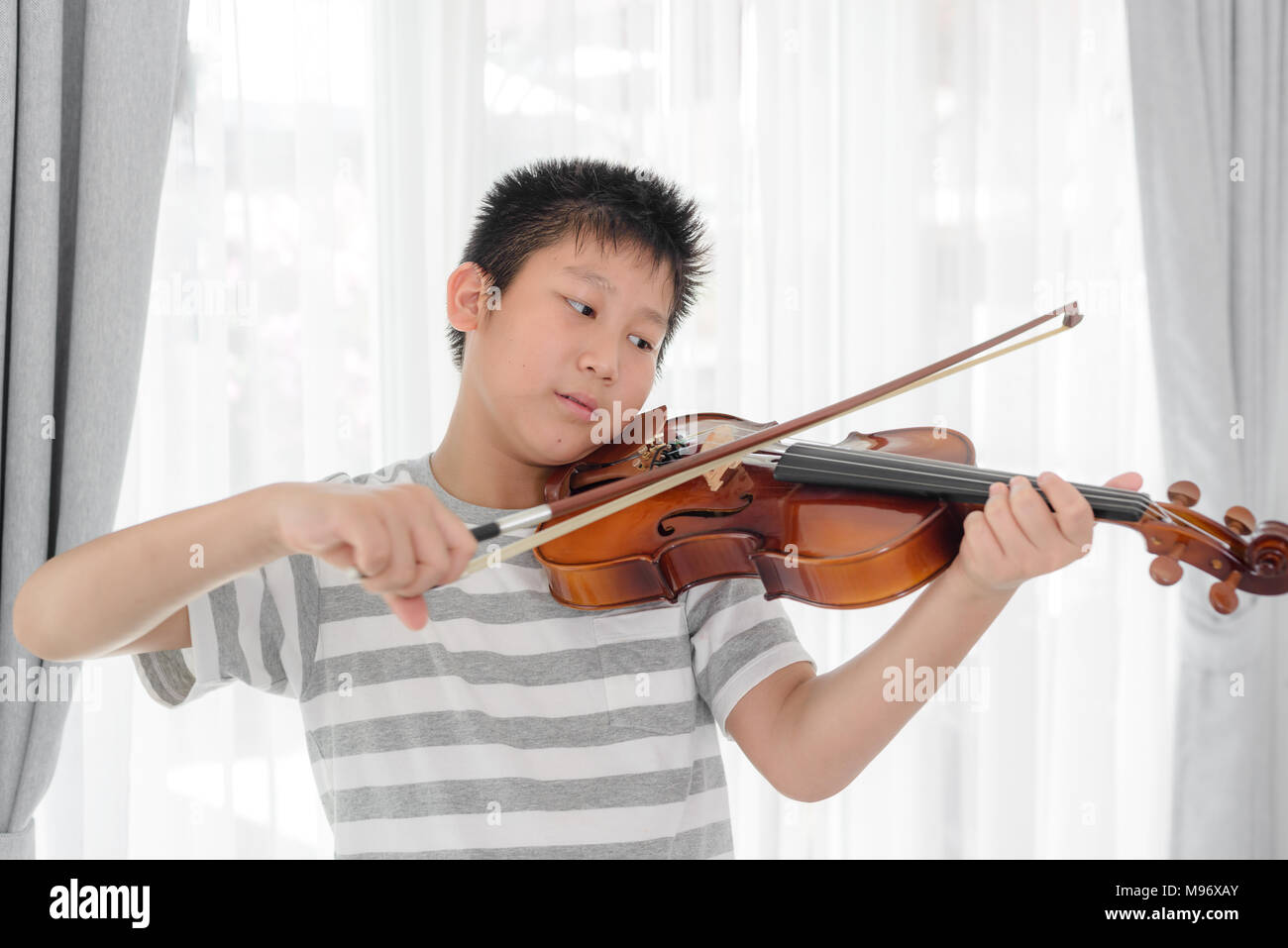 Boy playing violin hi-res stock photography and images - Alamy