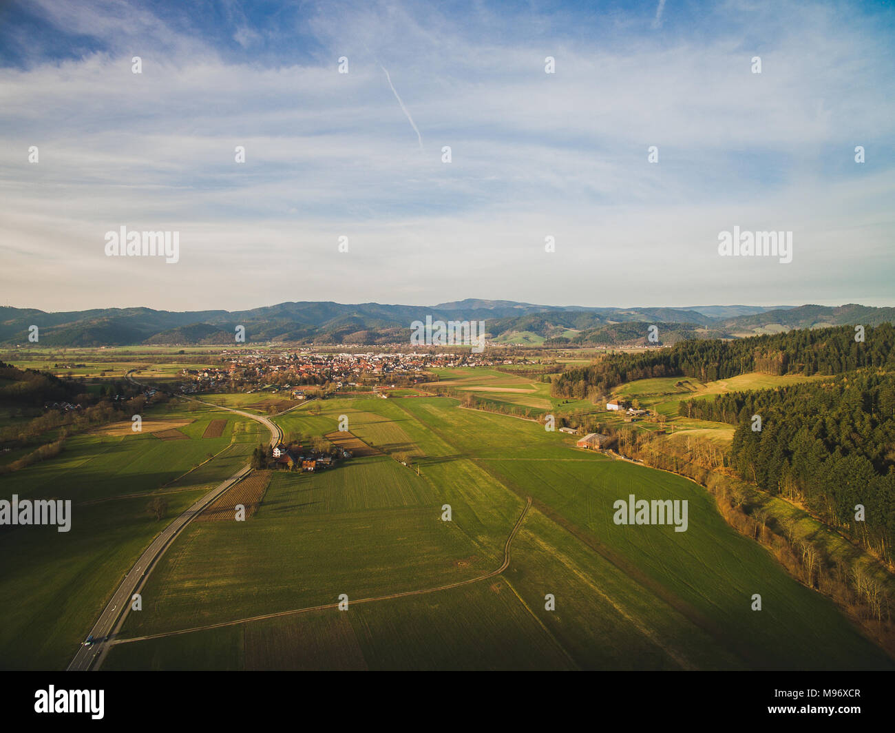 Aerial view of majestic landscape with green field and town in Germany ...