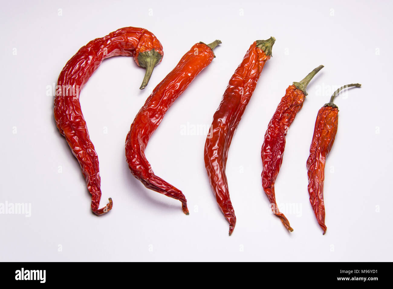 Dried red chilli peppers on white background Stock Photo - Alamy