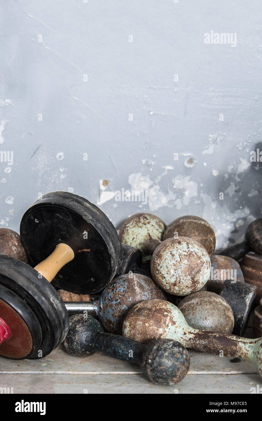 Old retro dumbbells are lying on the floor in the gym, sports gear ...