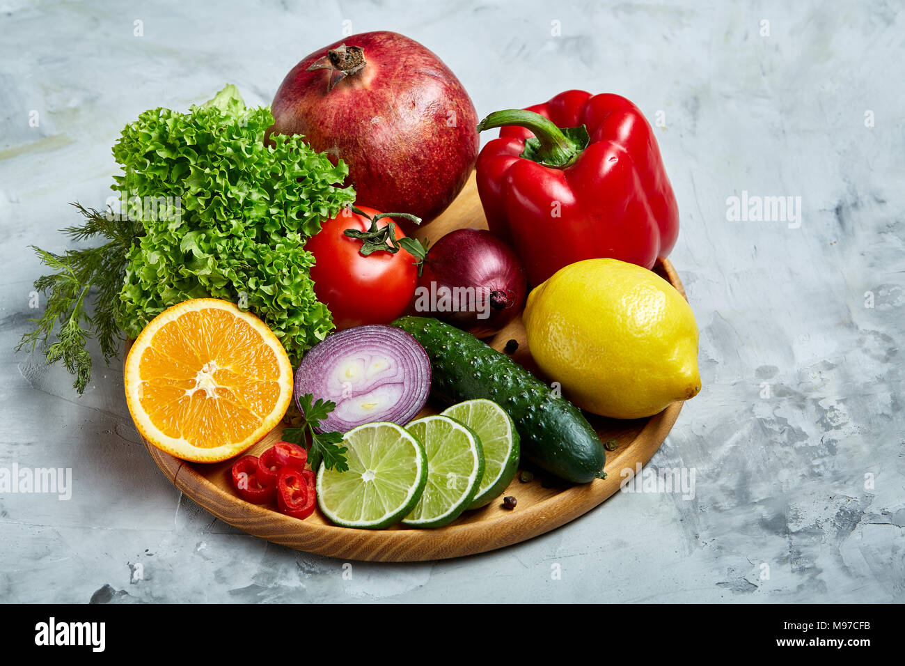 Colorful still life of fresh organic fruits and vegetables on wooden ...