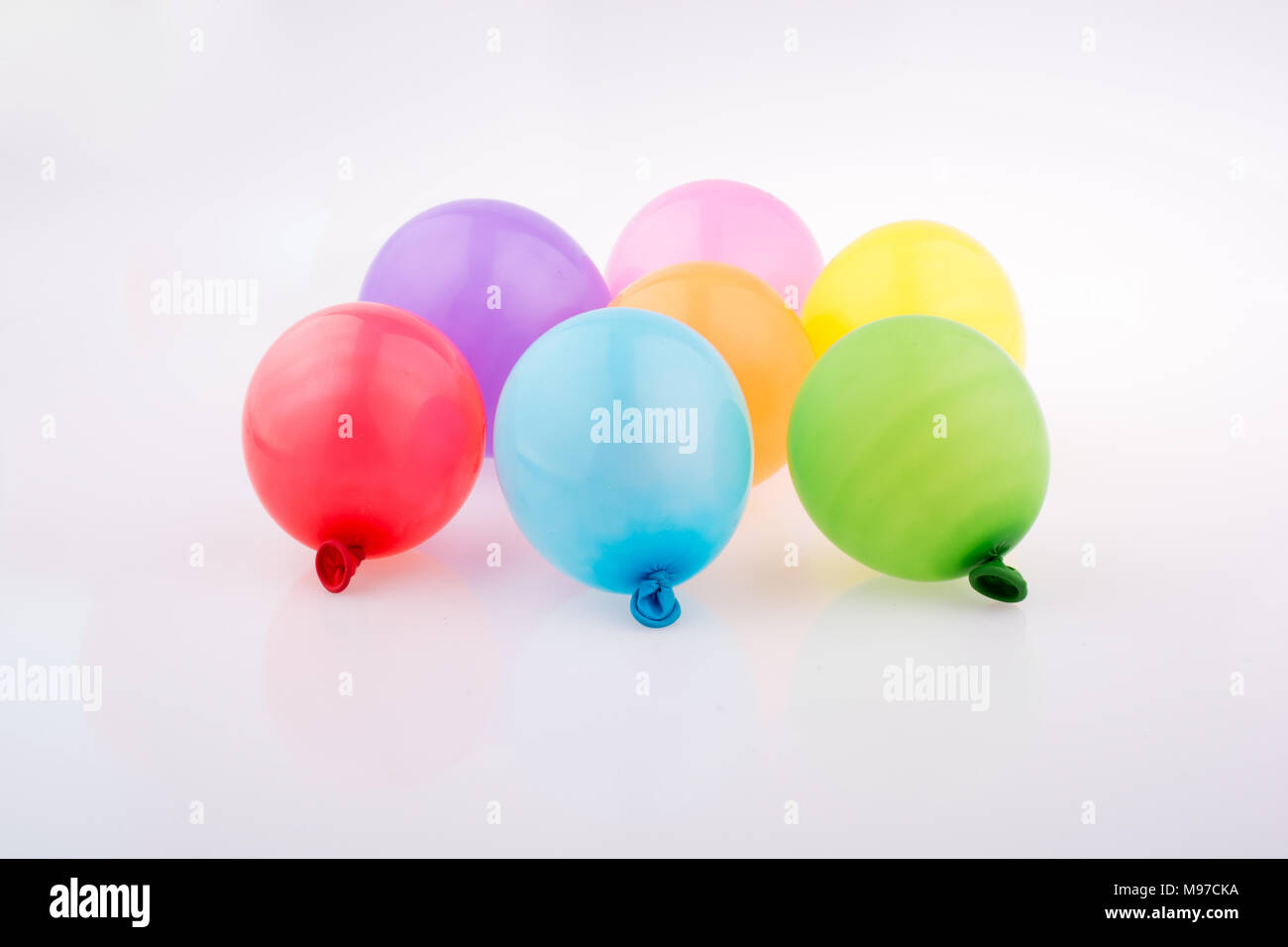 Colorful small balloons on a white background Stock Photo - Alamy