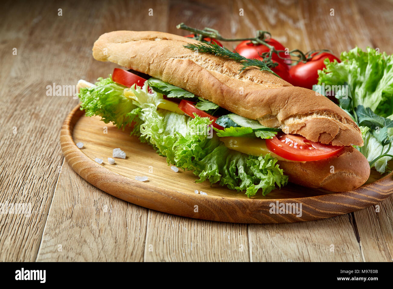Fresh homemade sub sandwich with lettuce, tomatoes and cheese served ...