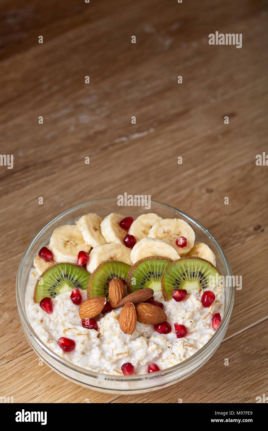 Delicious oatmeal porrige with kiwi, banana, pomergranate seeds and ...