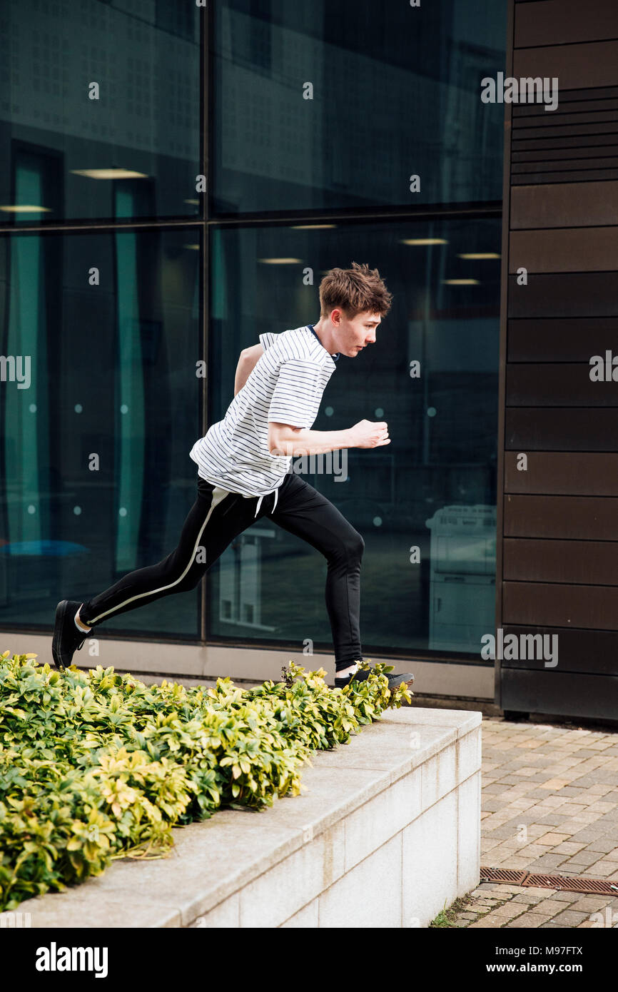 Freerunner is jumping between walls in the city Stock Photo - Alamy