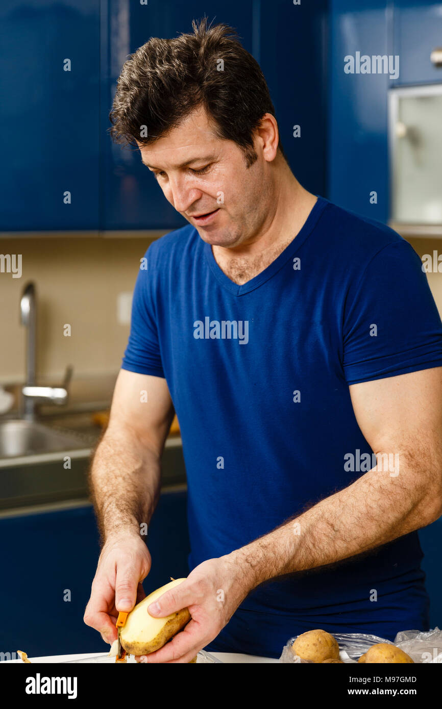 Man peeling raw potato on hi-res stock photography and images - Alamy