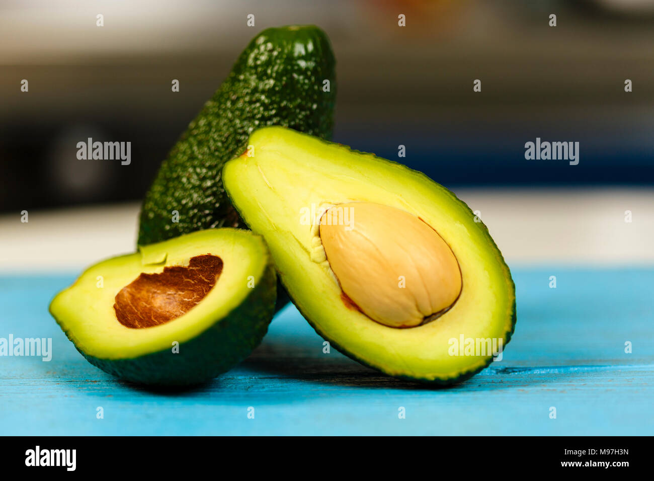 Closeup of fresh avocado fruit, whole and halved Stock Photo - Alamy