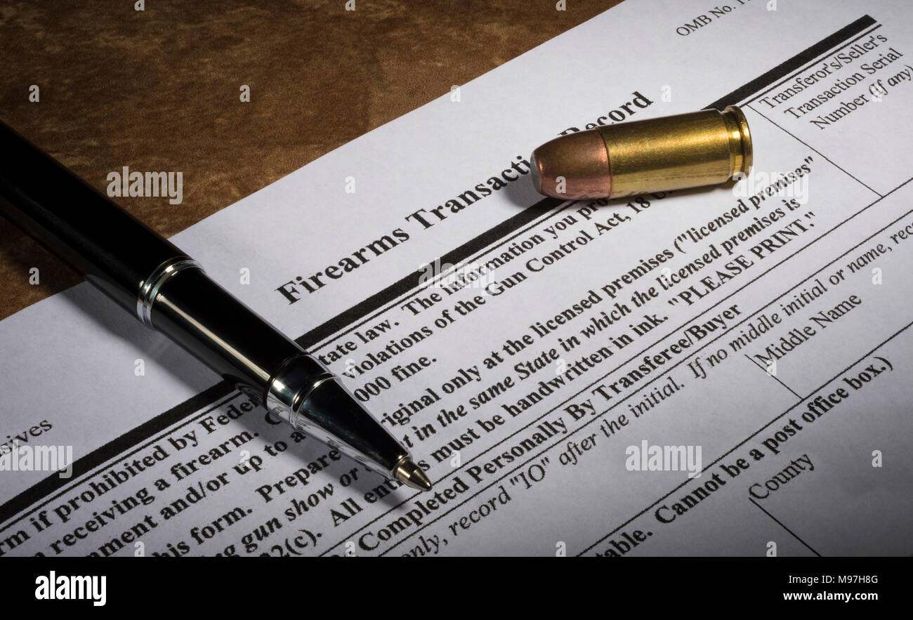 FBI's form for checking background before a gun buy with pen and ...