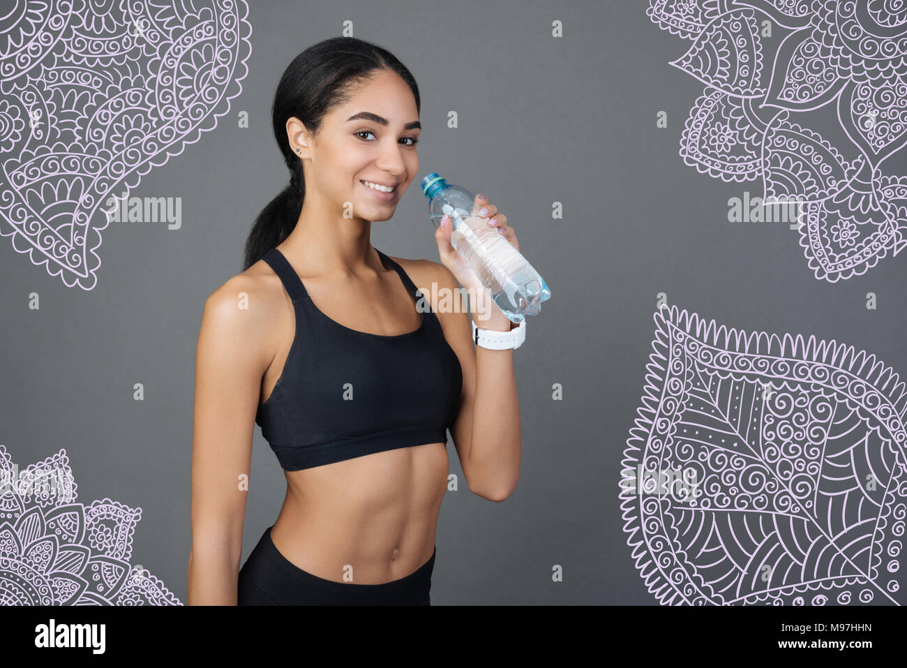Slim young thirsty woman smiling and drinking fresh water Stock Photo - Alamy