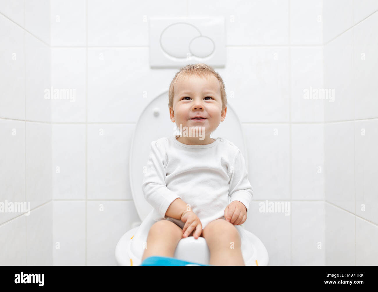 Adorable young child sitting and learning how to use the toilet Stock ...