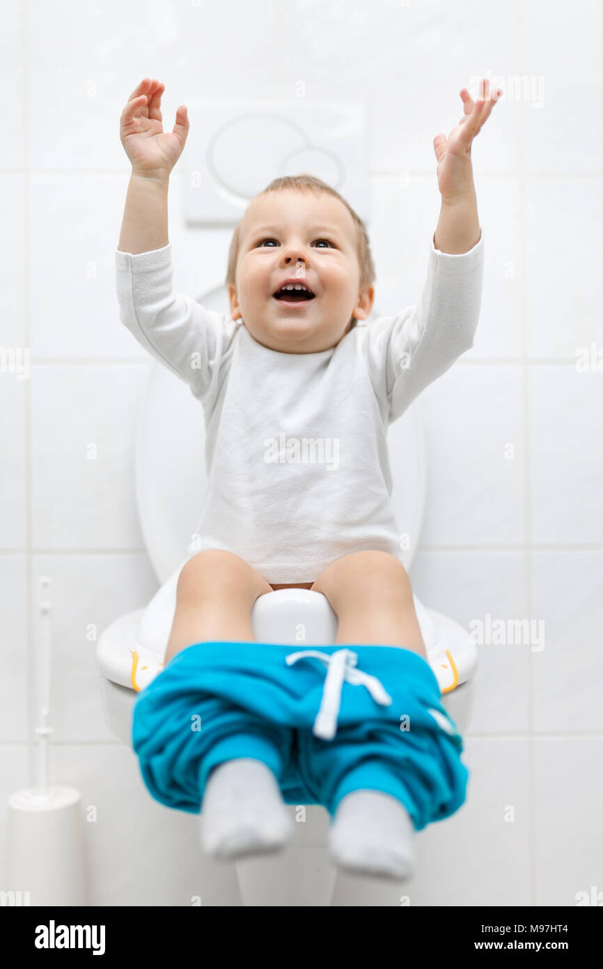 Adorable young child sitting and learning how to use the toilet Stock ...