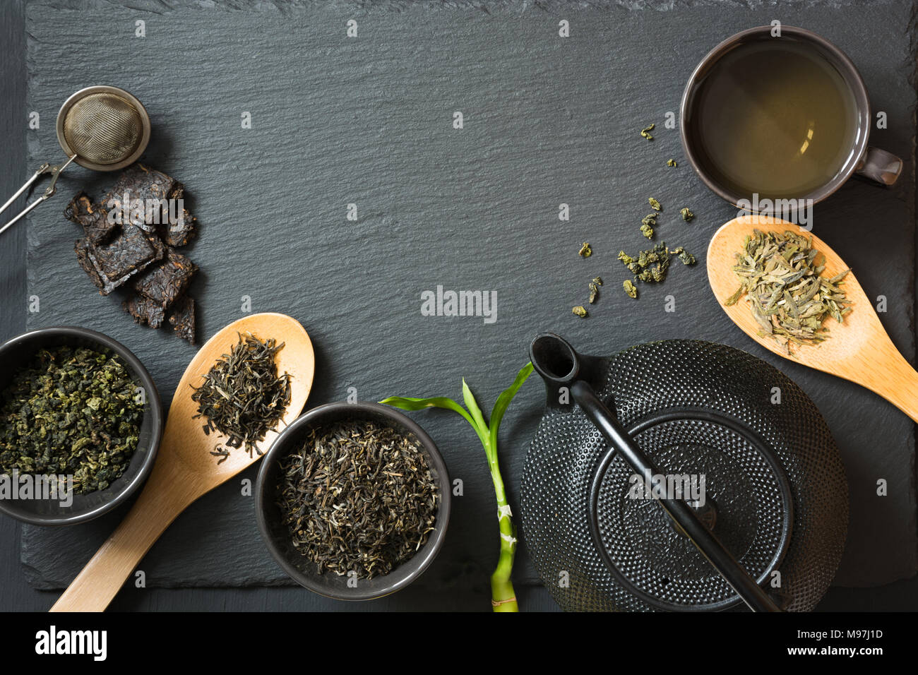 Different kinds of green japanese and chinese tea in bowls on black ...