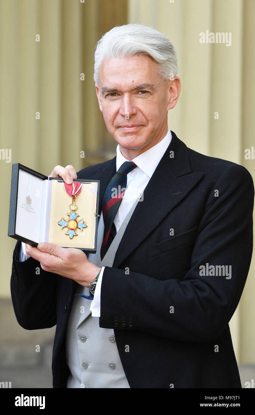 Brigadier Alastair Aitken holds his CBE following an investiture ...