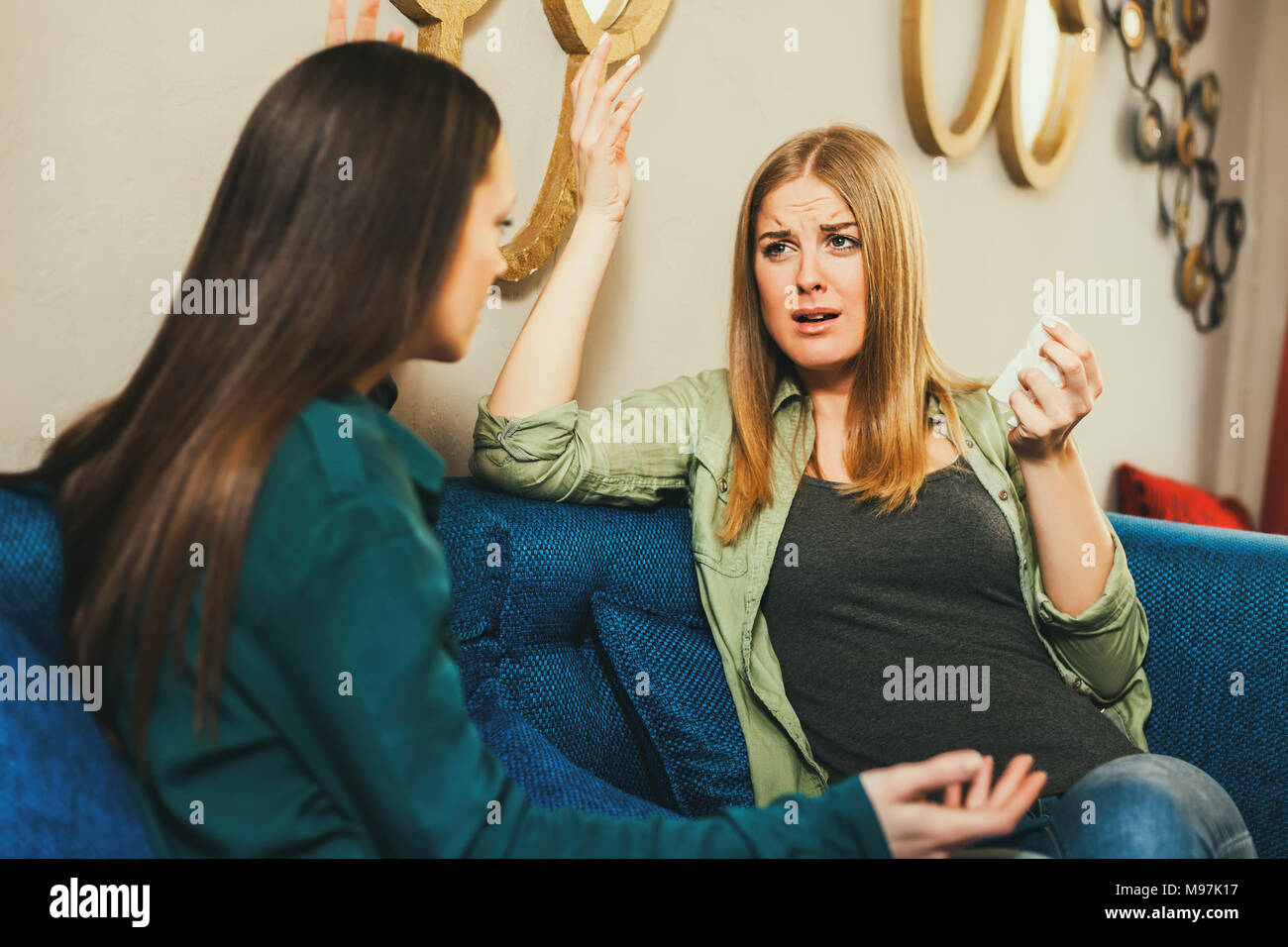 Young woman is sad, she is talking to a friend in cafe Stock Photo - Alamy