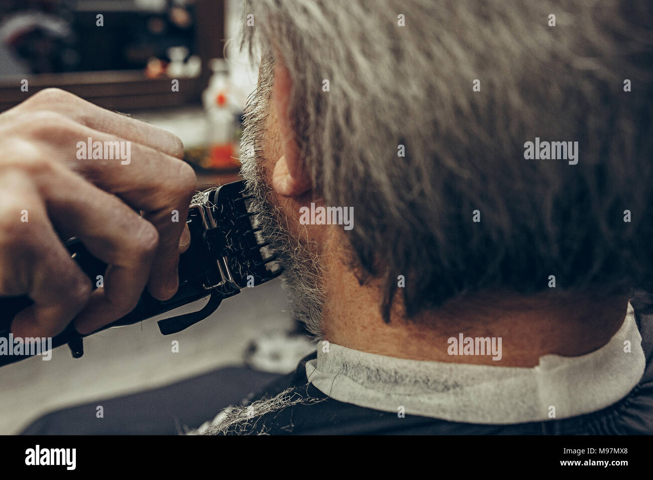 Close-up side back view handsome senior bearded caucasian man getting ...