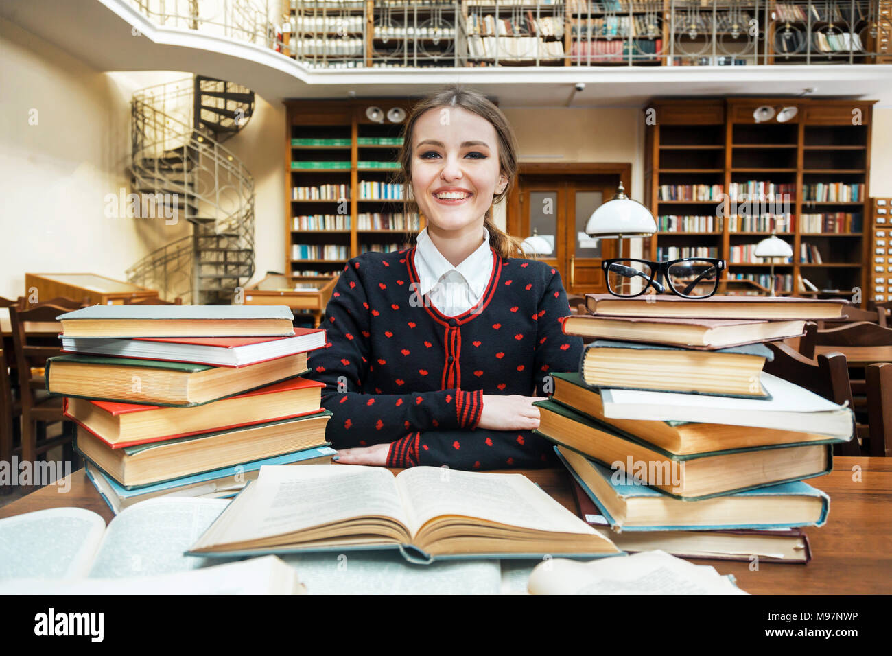 Girl with Books in the Library Stock Photo - Alamy