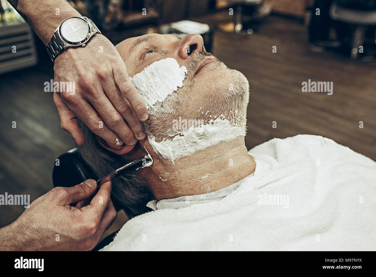 Close-up side top view handsome senior bearded caucasian man getting ...