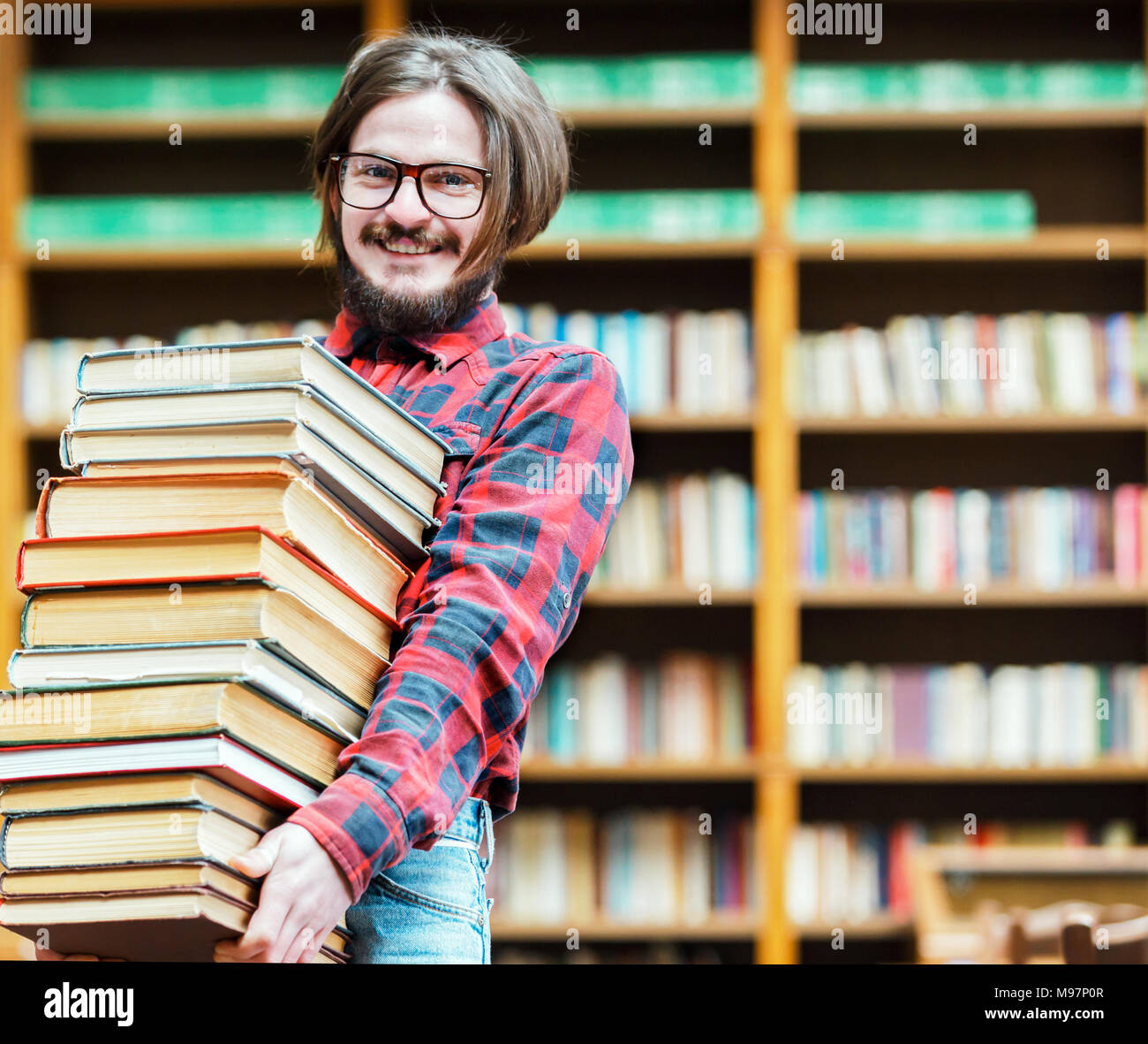 Student Man Holds Stack of Books Stock Photo - Alamy