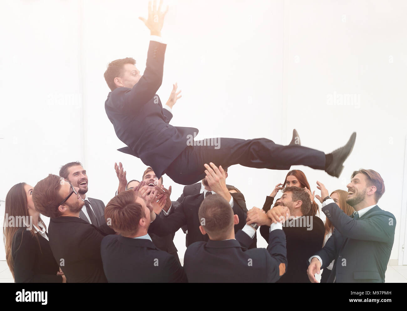 large business team rocking their leader. success concept Stock Photo ...