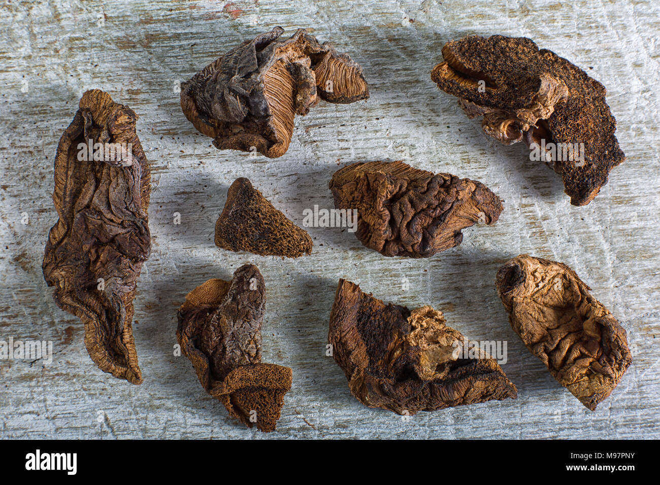 dried mushroom pieces on rustic surface Stock Photo - Alamy