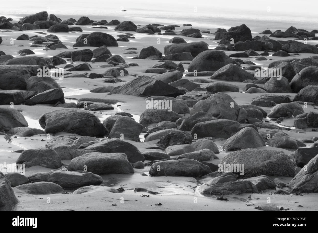 Low tide at this beach shows off the rocks and boulders Stock Photo - Alamy