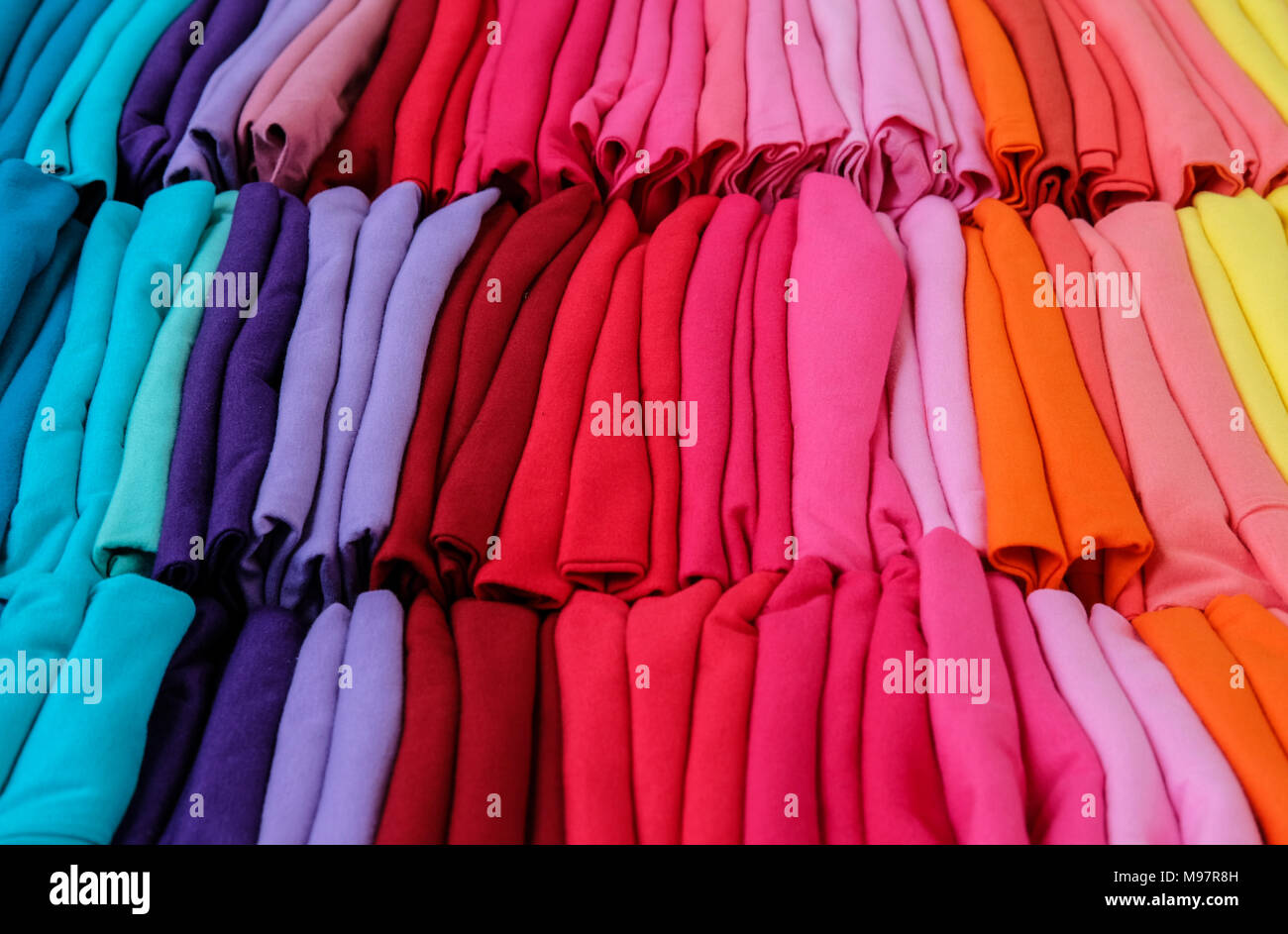 Stack of colorful t-shirts for sale Stock Photo - Alamy