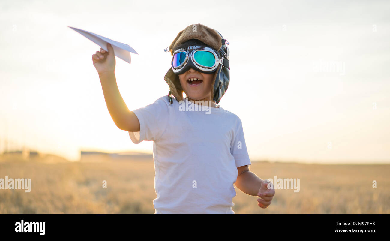Kid, Little boy wearing helmet and dreams of becoming an aviator while ...