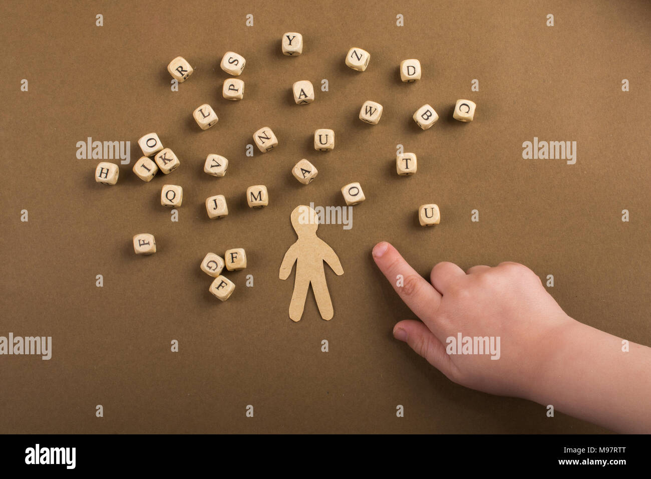 Letter cubes of made of wood and man figurine Stock Photo - Alamy