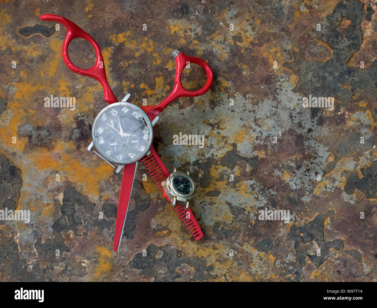 Red stylish hairdresser scissors with graceful handles on rusty ...