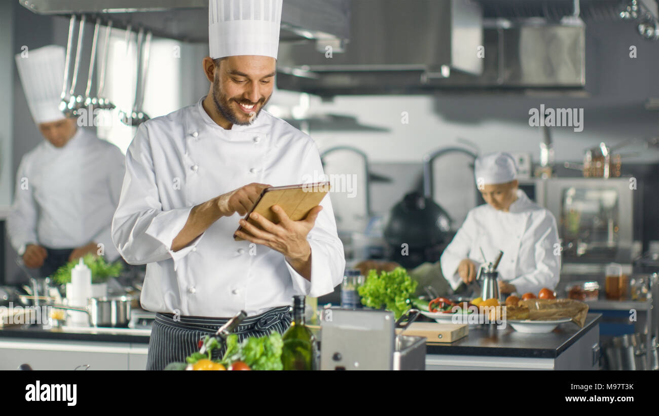 Famous Chef Uses Tablet Computer for Recipes While Working in a Modern ...