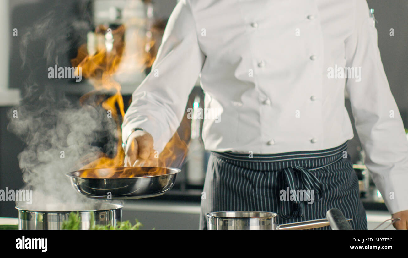 Close-up Shot of Fireing Oil on a Pan. Flambe Style Cooking. Cook Works ...