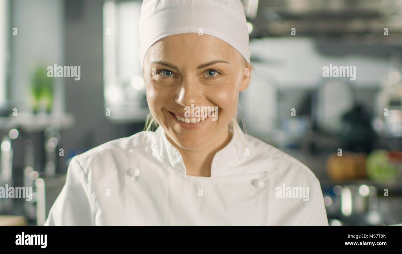 Portrait of a Young Woman Chef Smiling While Cooking in a Modern ...