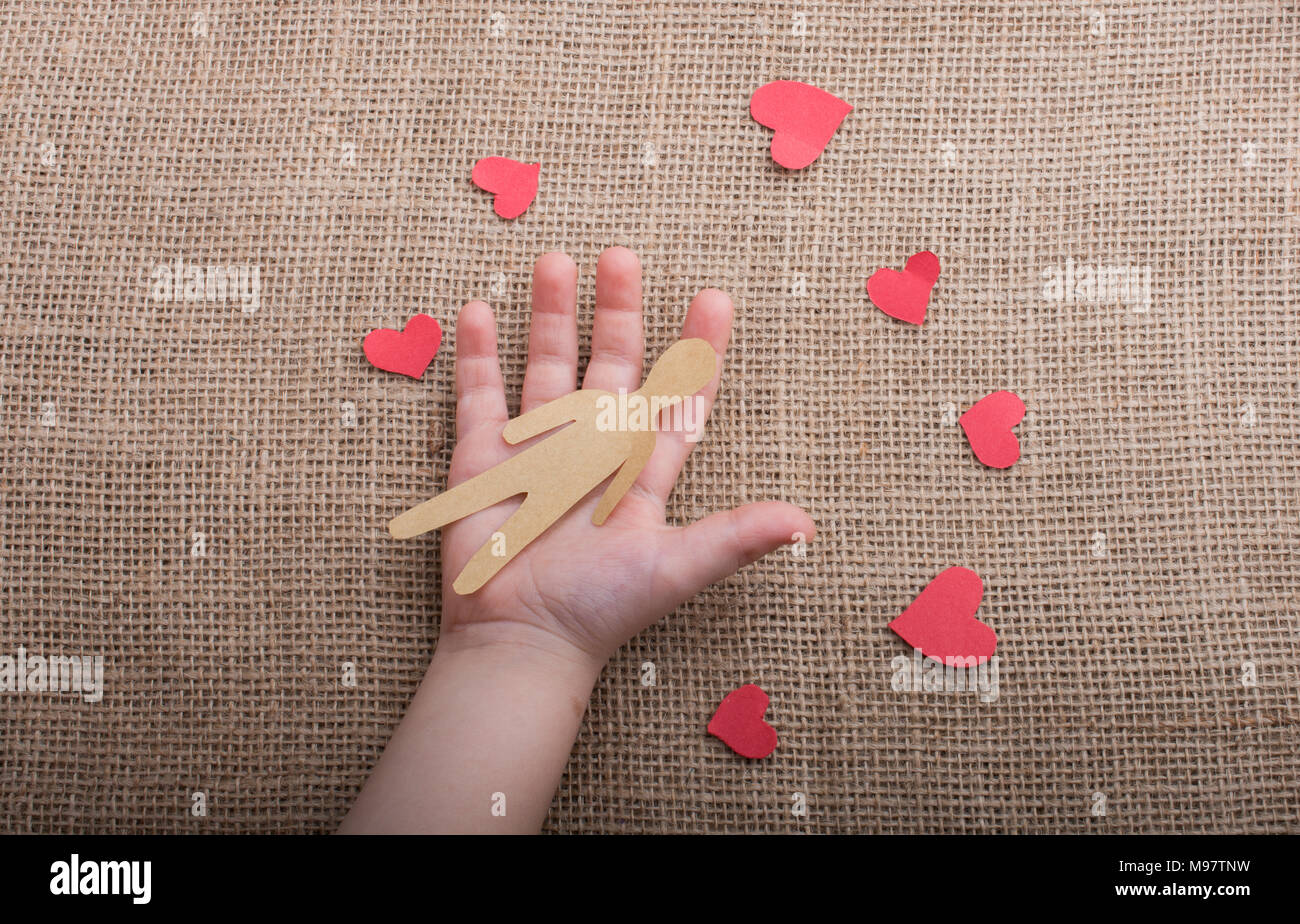 Man and heart shape cut out of paper in hand Stock Photo - Alamy