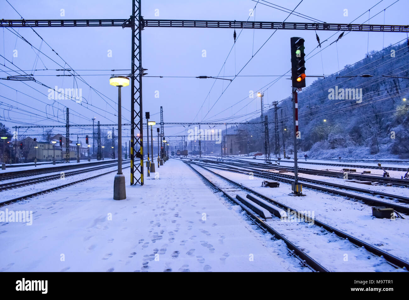 Morning train station platform in winter with snow Stock Photo - Alamy
